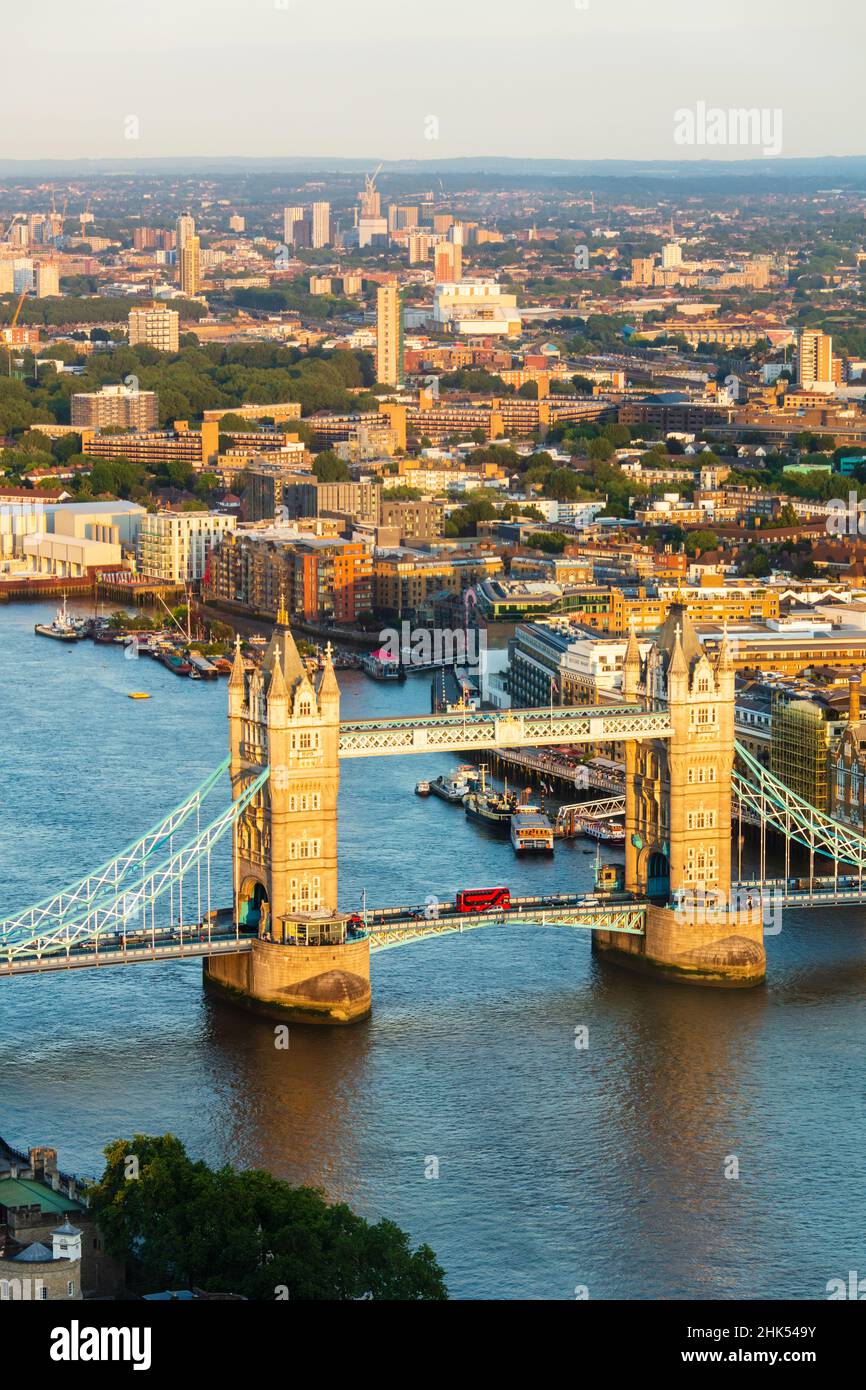 Red London bus crossing Tower Bridge, from above, London, England ...