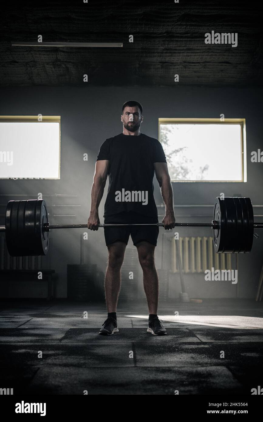 Athletic Bodybuilder Stand With Heavy Barbell Stock Photo - Alamy