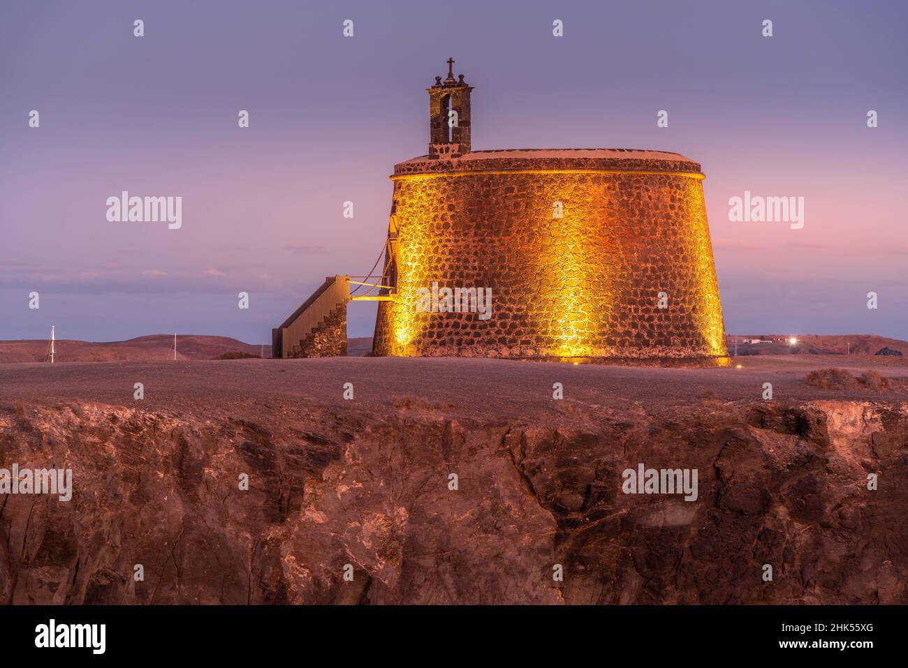 View of Castillo del Aguila o de las Coloradas at dusk, Playa Blanca ...