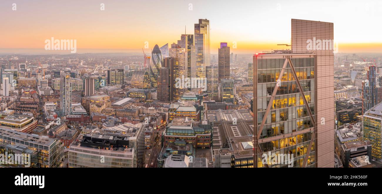 Panoramic view of City of London skyscrapers and Tower Bridge at dusk ...
