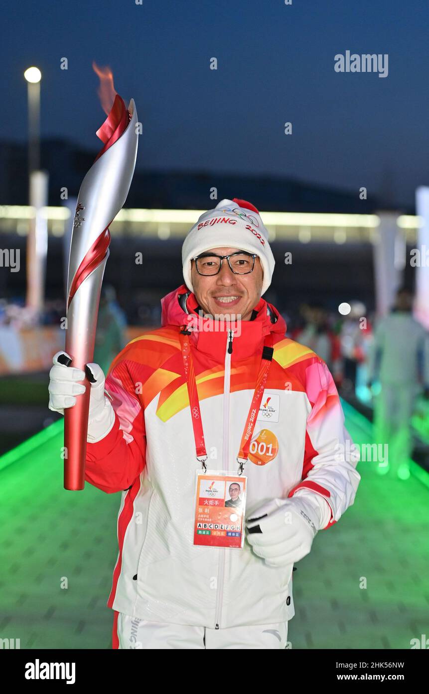 Beijing, China. 2nd Feb, 2022. Torch bearer Zhang Li runs with the torch during the Beijing 2022 ...