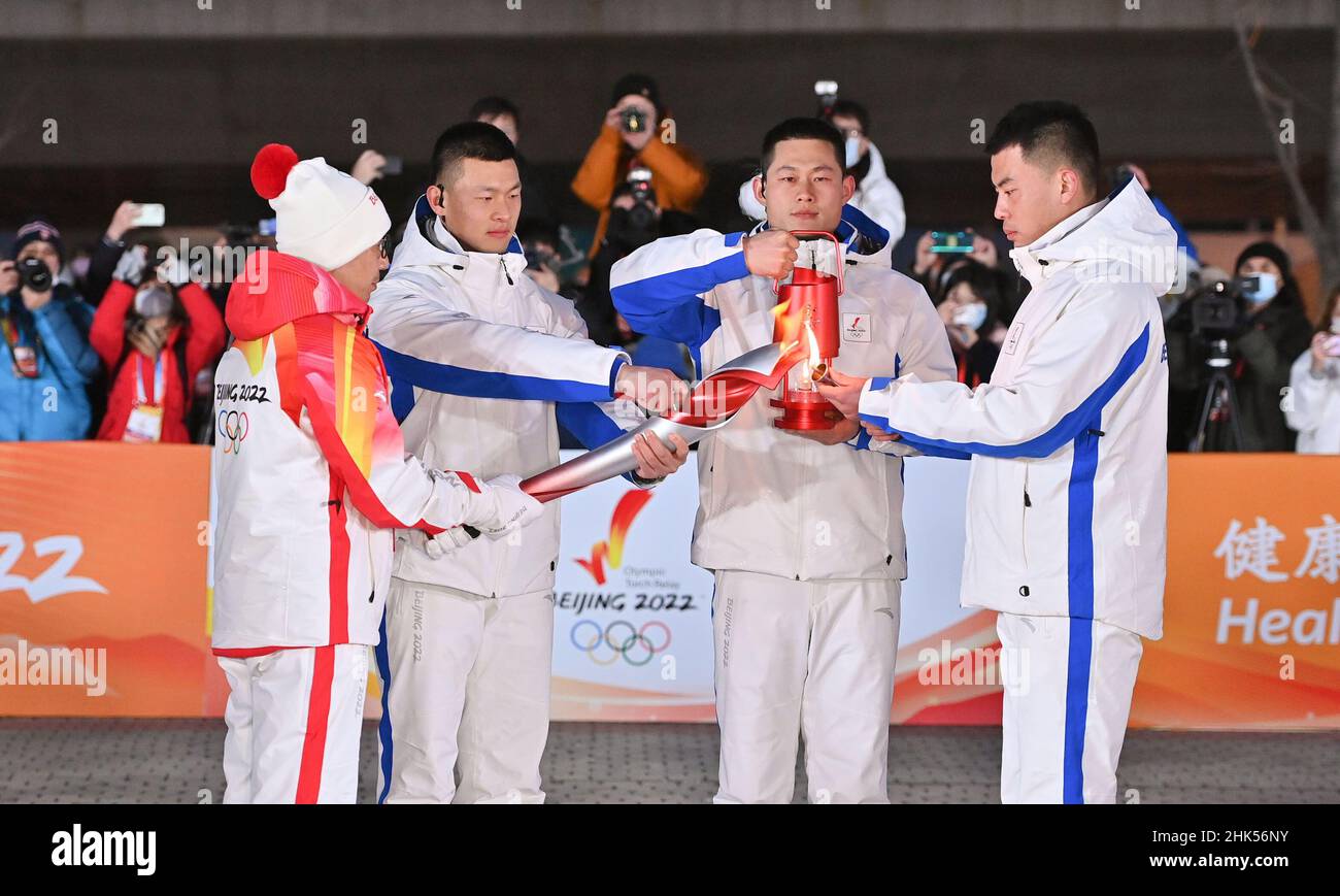 Beijing, China. 2nd Feb, 2022. Zhang Li lights the torch of the first torch bearer during the ...