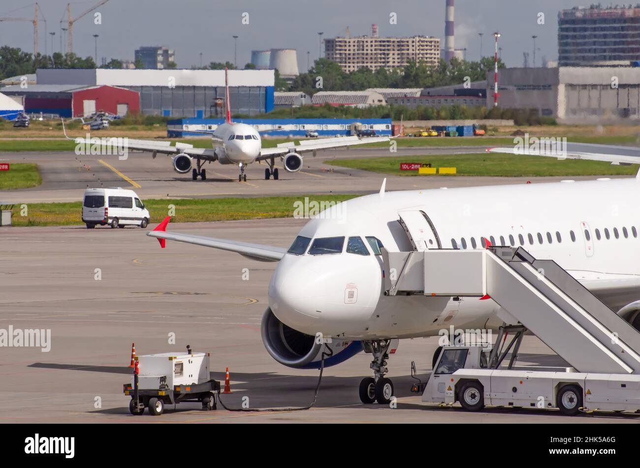 Airplane with a ladder ladder waiting for passengers, in the distance ...