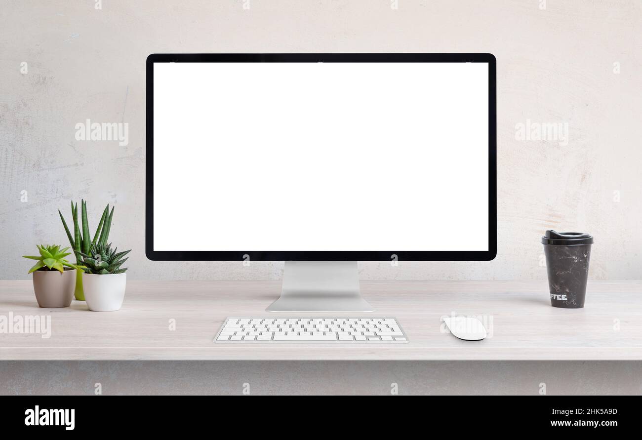 Computer display on work desk with white, isolated screen for web page ...