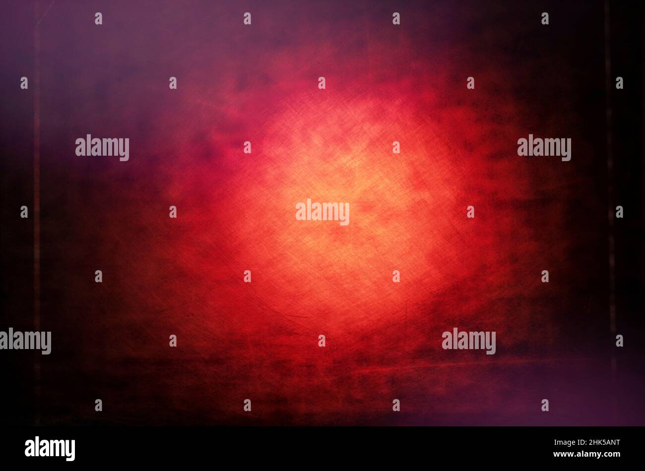 Red grunge background with a dark vignette and a light spot in the ...