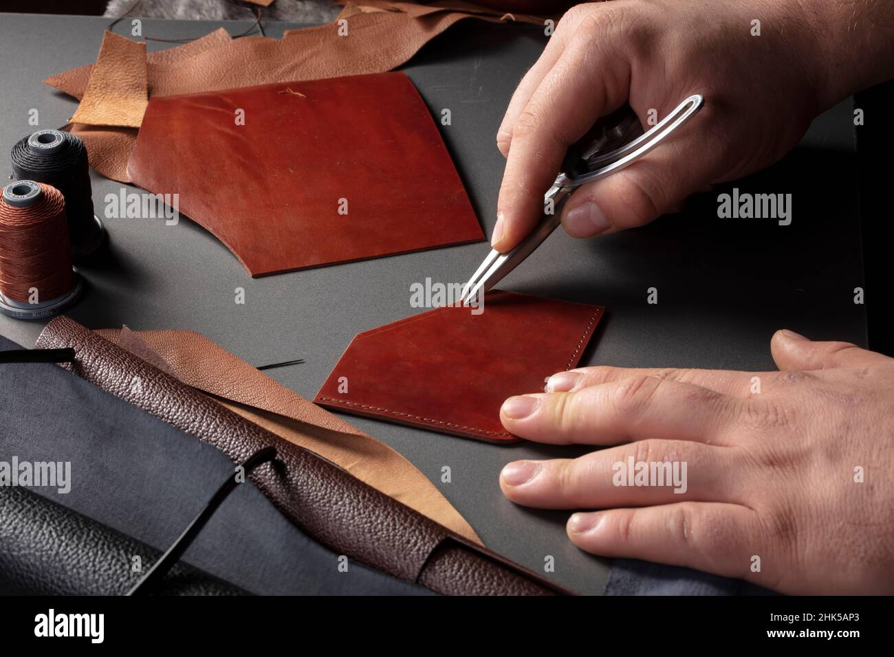 The process of making leather goods. The hands of the master work with ...