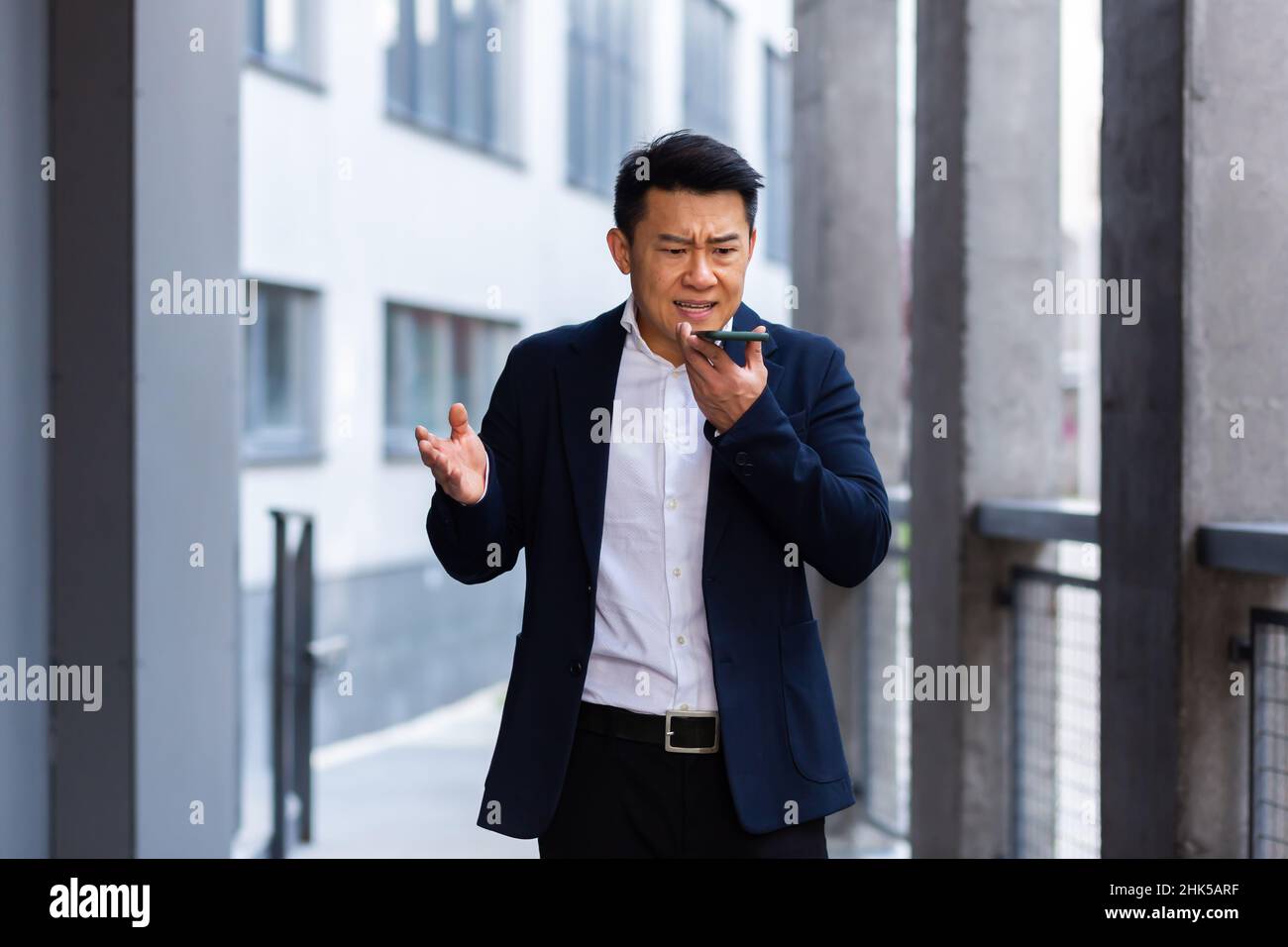 angry and serious Successful Asian businessman explains information to ...