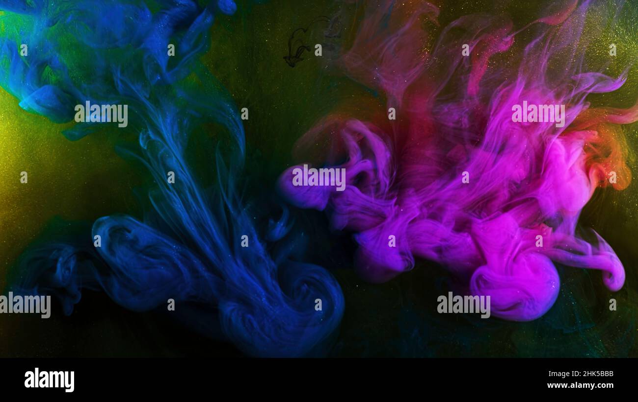 Beautiful splash of multicolored ink mixing in water. Stock footage ...