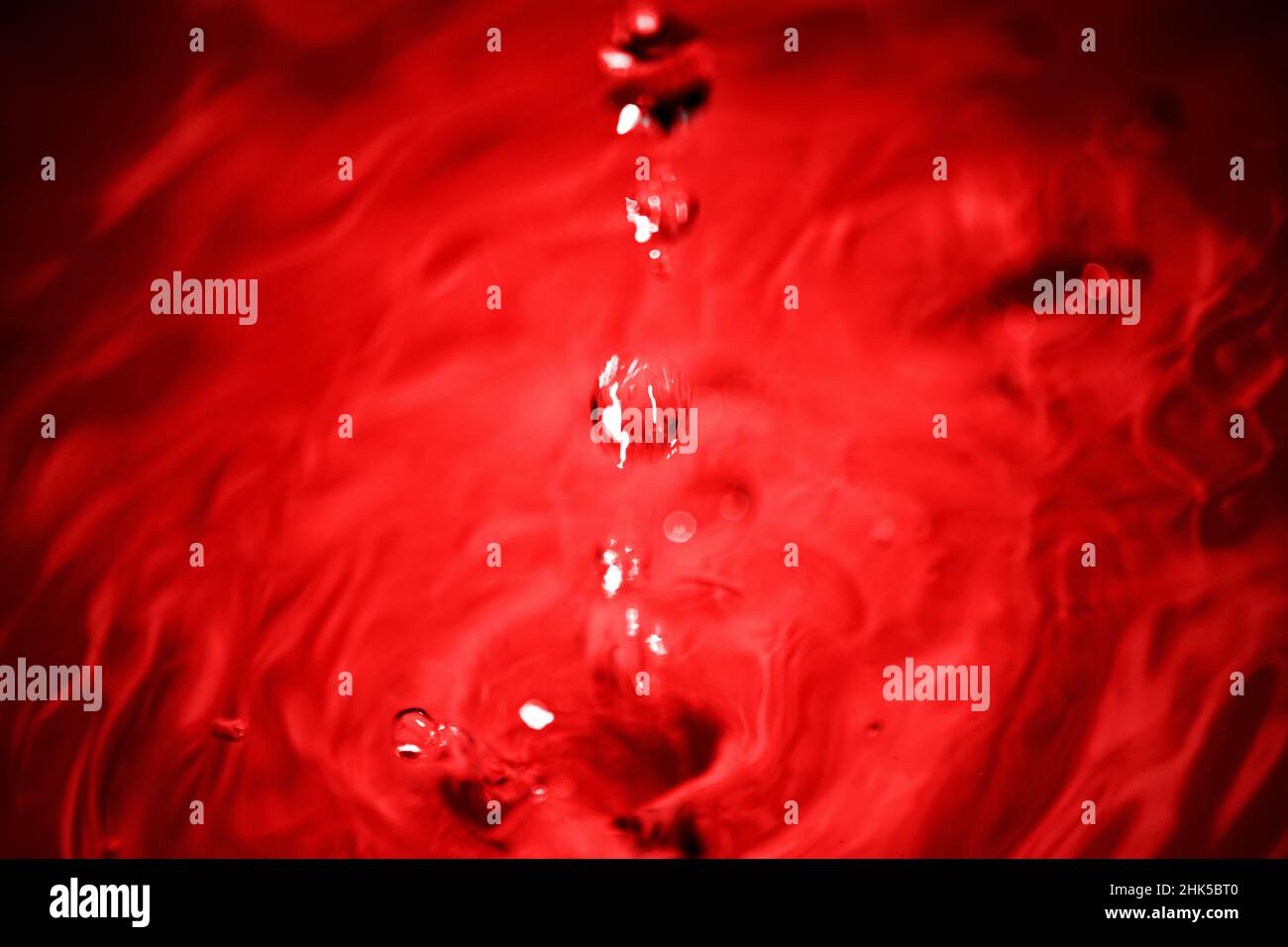 Red drop or red water. Water drop ripples and liquid motion color ...