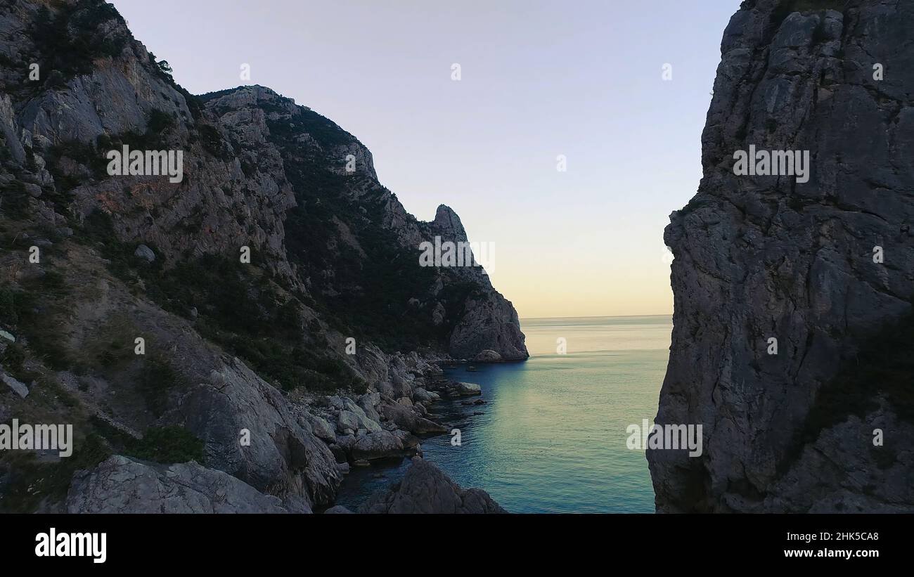 Top view of wild cliffs with blue sea on sky background. Shot. Rocky ...