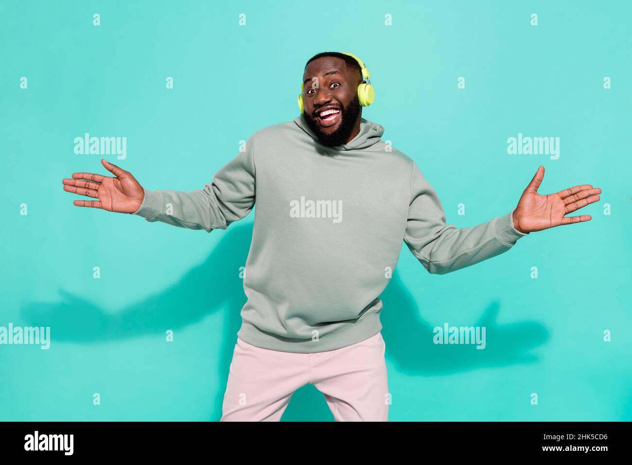 Portrait of cheerful attractive guy dancing listening pop hit single ...