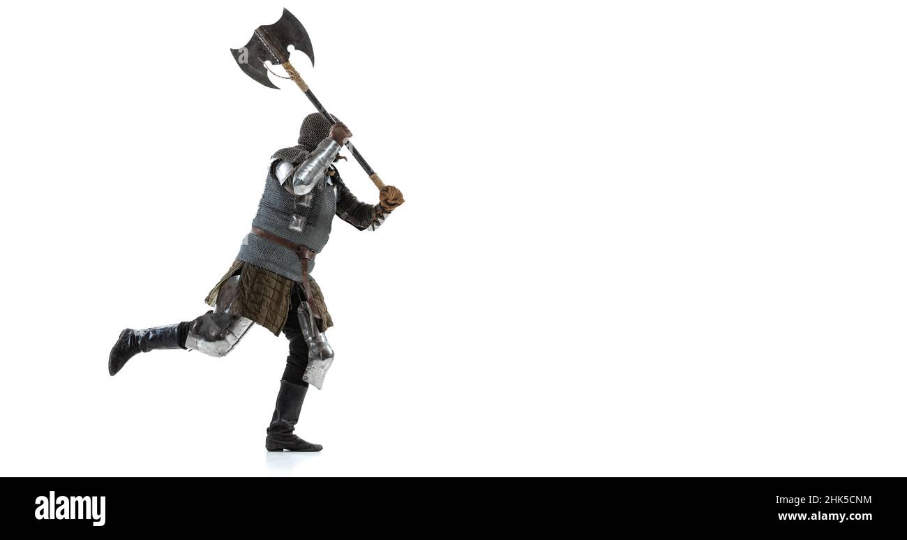 Full-length side view portrait of medieval warrior, knight running with ...