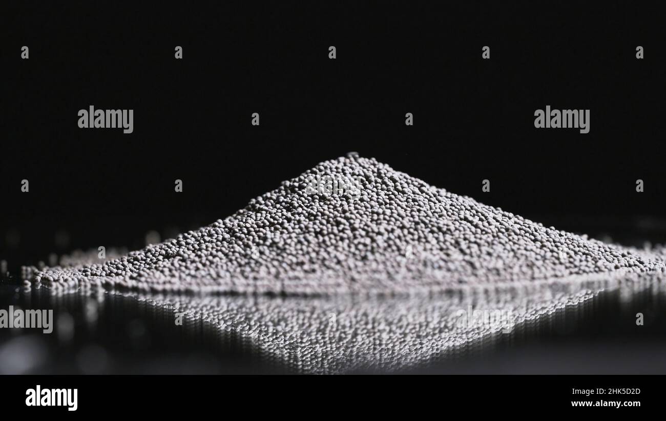 Pile of stones isolated over black background. Close up of small rubble ...