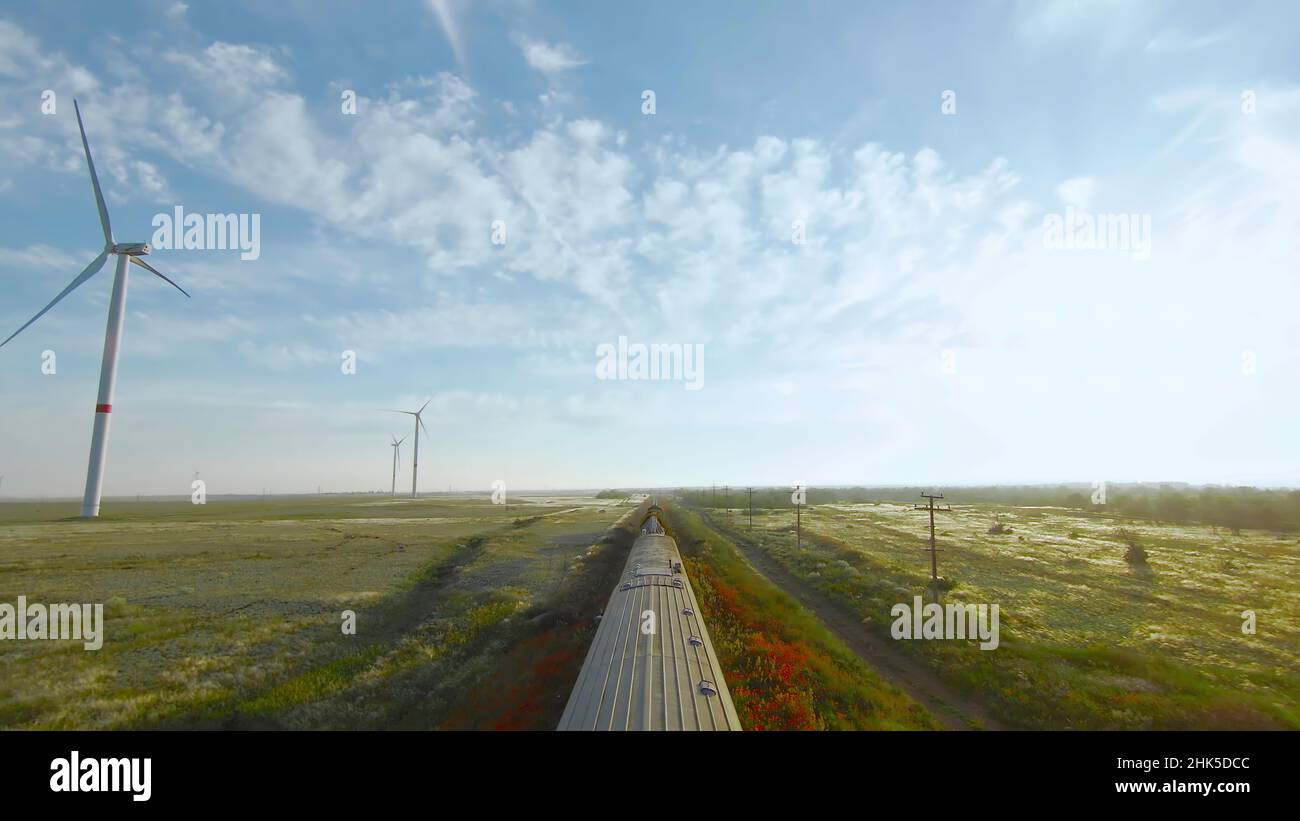 Top view of freight train on green field background. Shot. Drone ...