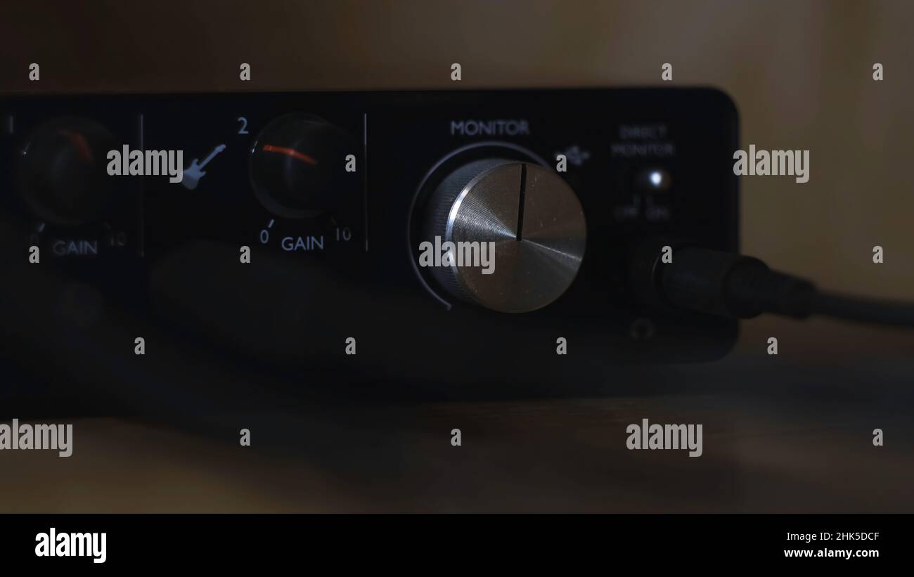 Audio interface with plugged in headphone jack. Close up of a hand ...