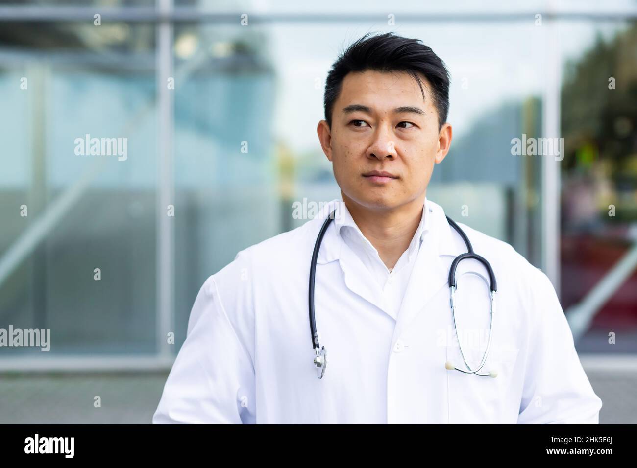 portrait of a stern and serious asian male doctor on the background of ...