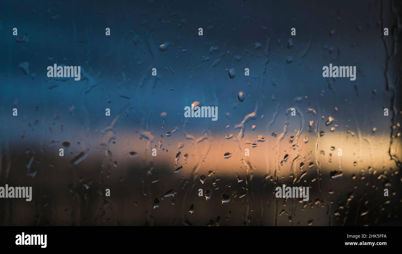 Close-up of window with raindrops background cloudy sky. Concept ...