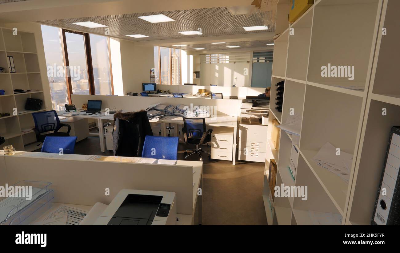 View of business office with one employee sitting at work alone. View ...
