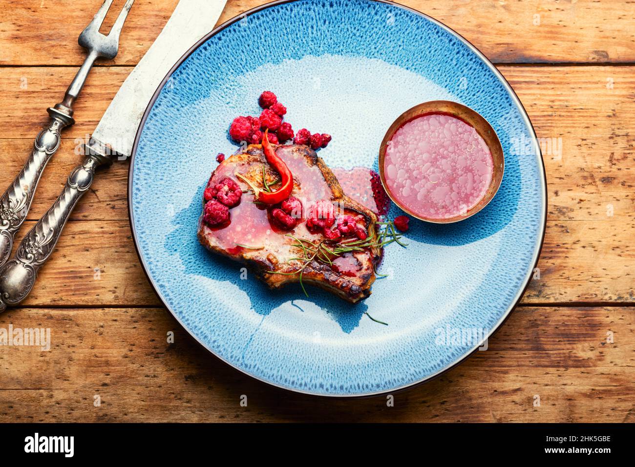 Delicious juicy fried pork with raspberry sauce Stock Photo - Alamy