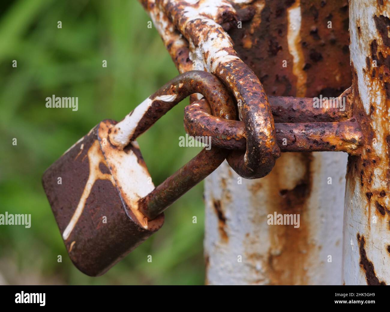 Rusty padlock hanging in the street alley Stock Photo - Alamy