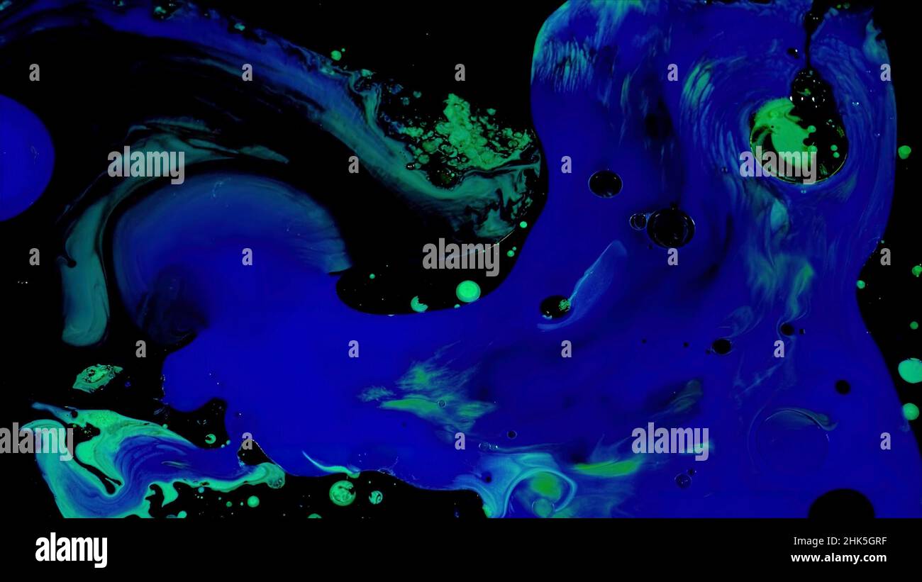 Fluid art on water. Footage. Beautiful streaks of colors with neon ...