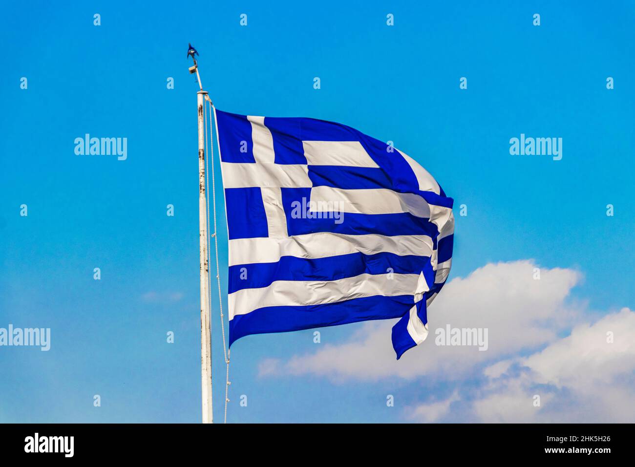 Greek blue and white flag with blue sky background at the Acropolis of ...