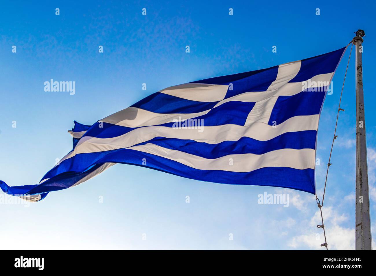 Greek blue and white flag with blue sky background at the Acropolis of ...