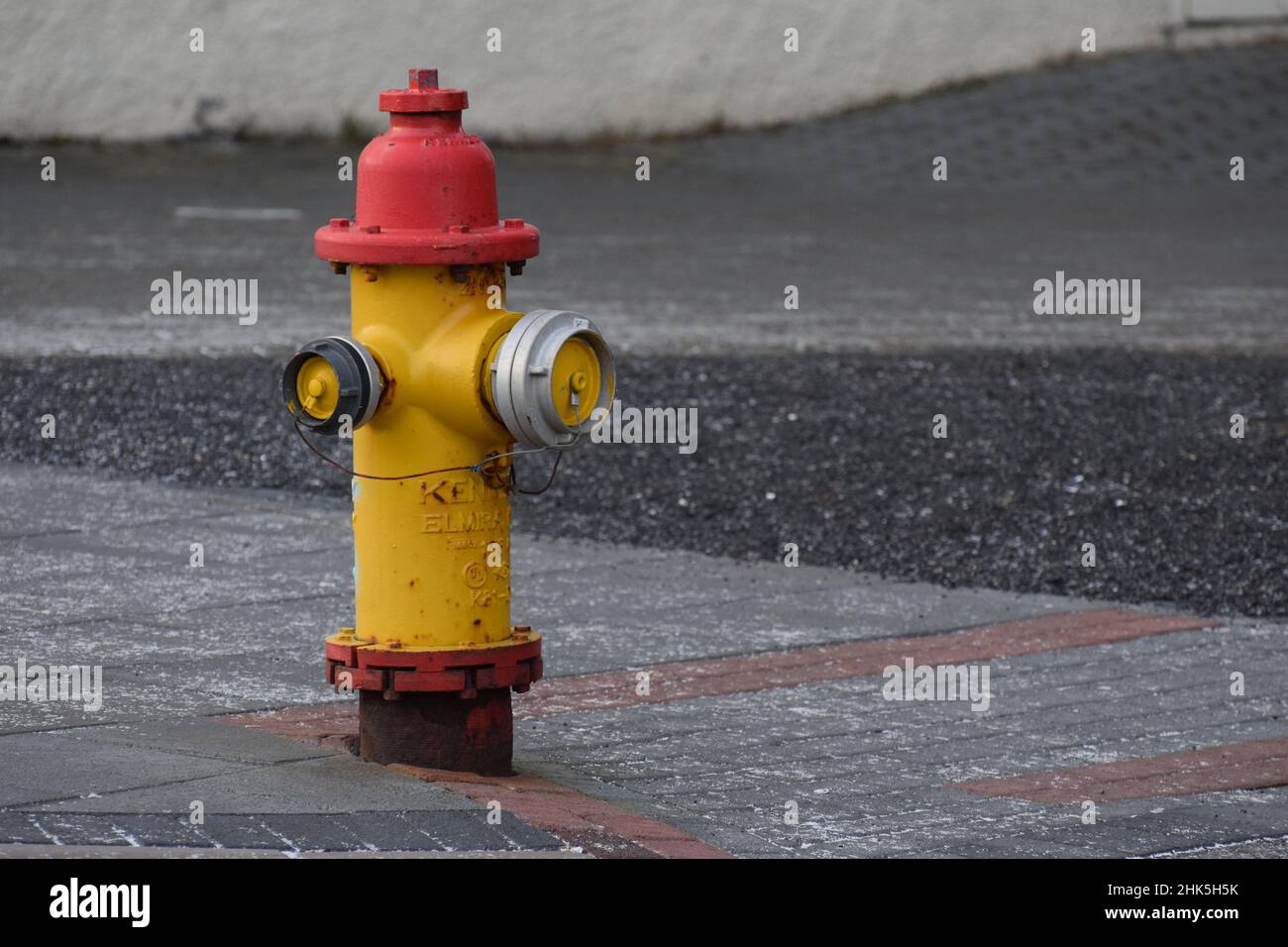 A traditional red and yellow fire hydrant in the street in Reykjavík ...
