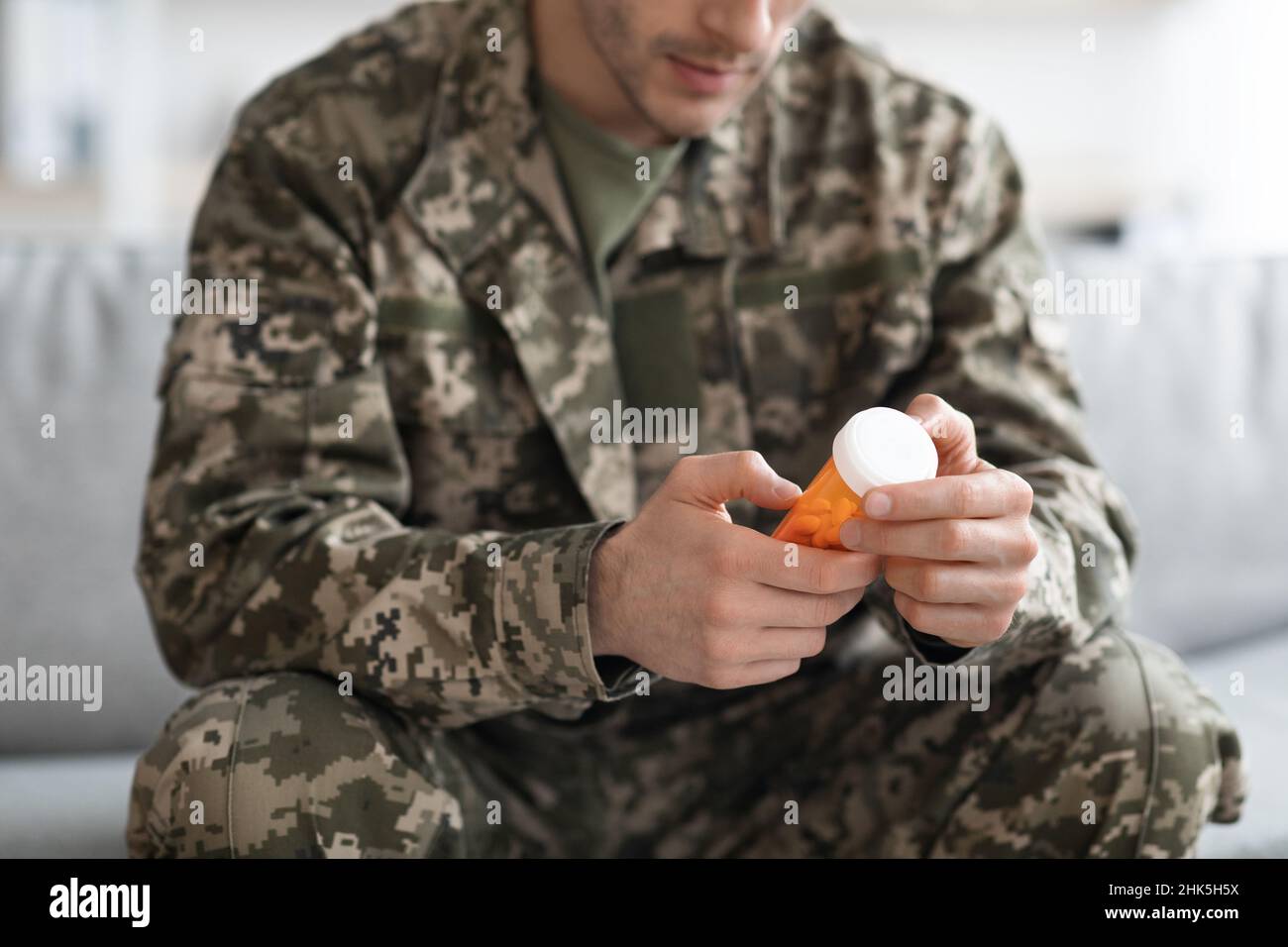 Unrecognizable soldier holding jar with medication, cropped Stock Photo ...