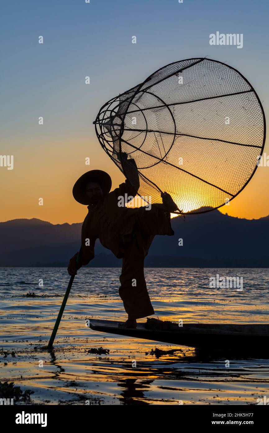 Intha leg rowing fishermen at sunset at Shan State, Inle Lake, Myanmar ...