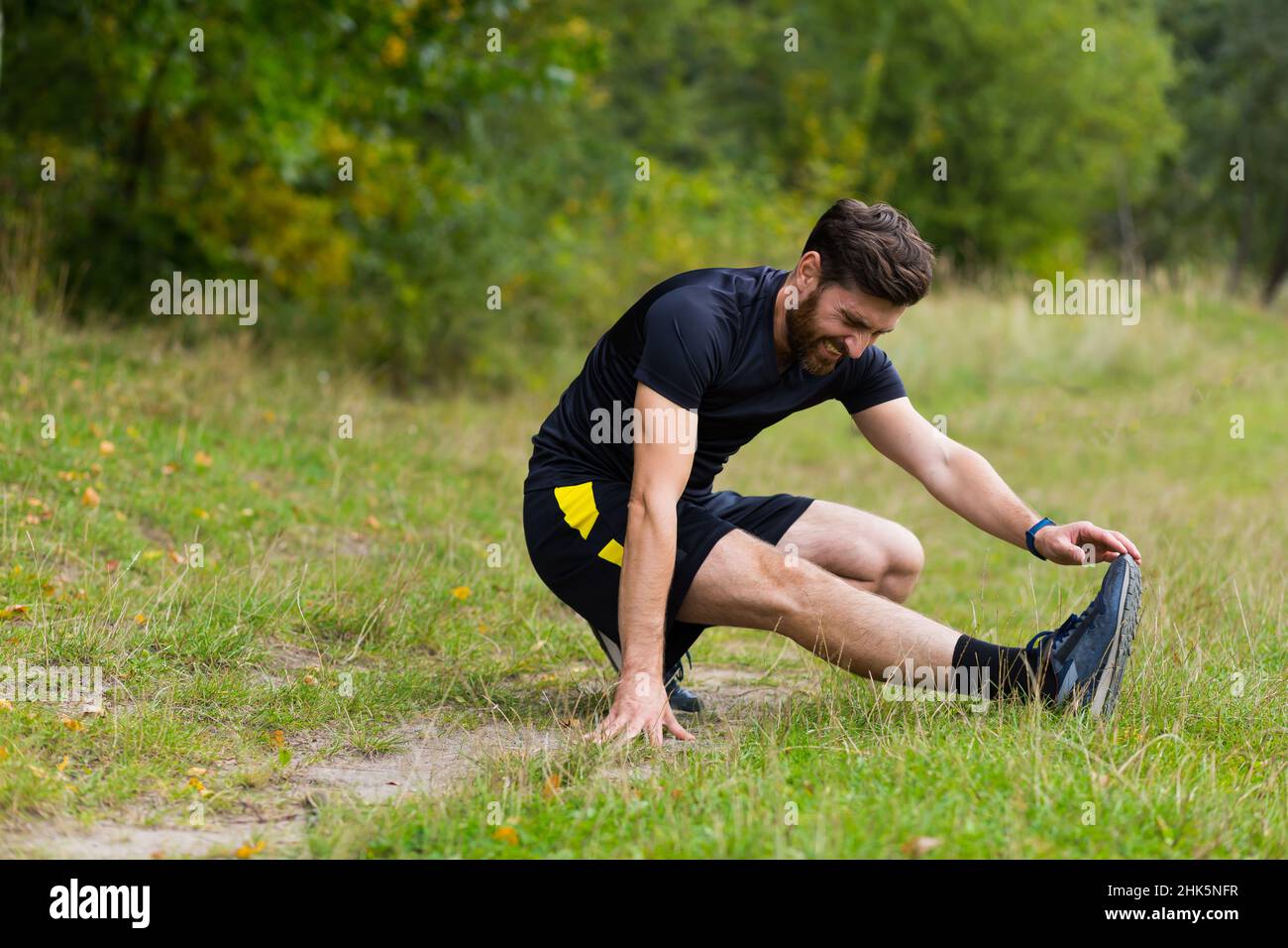 Athlete male injured during training, has severe leg pain, muscle aches ...
