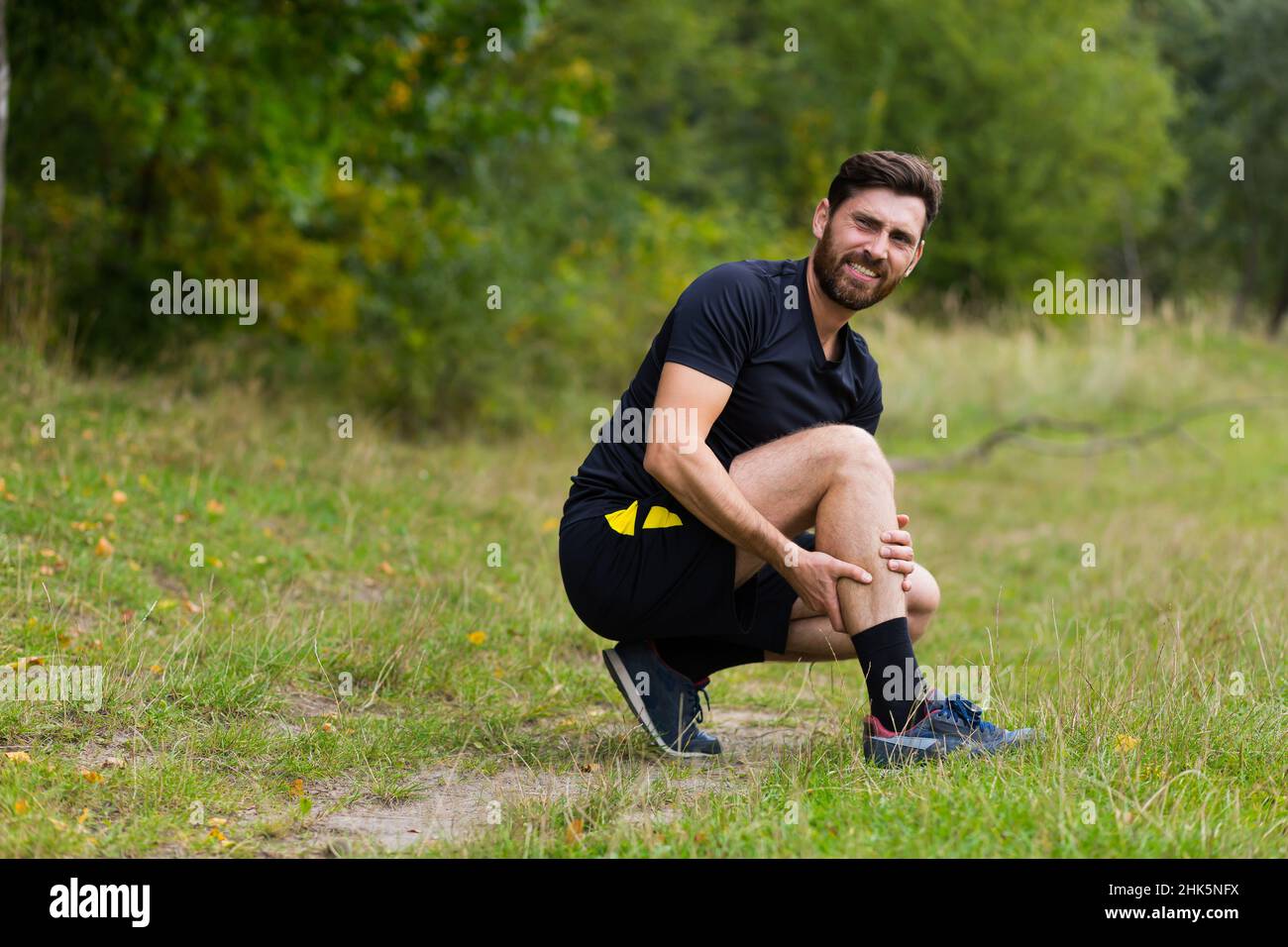 Athlete male injured during training, has severe leg pain, muscle aches ...