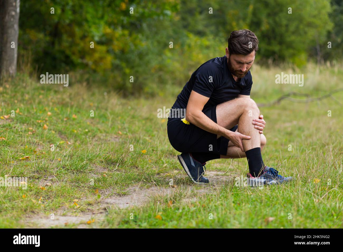 Athlete male injured during training, has severe leg pain, muscle aches ...
