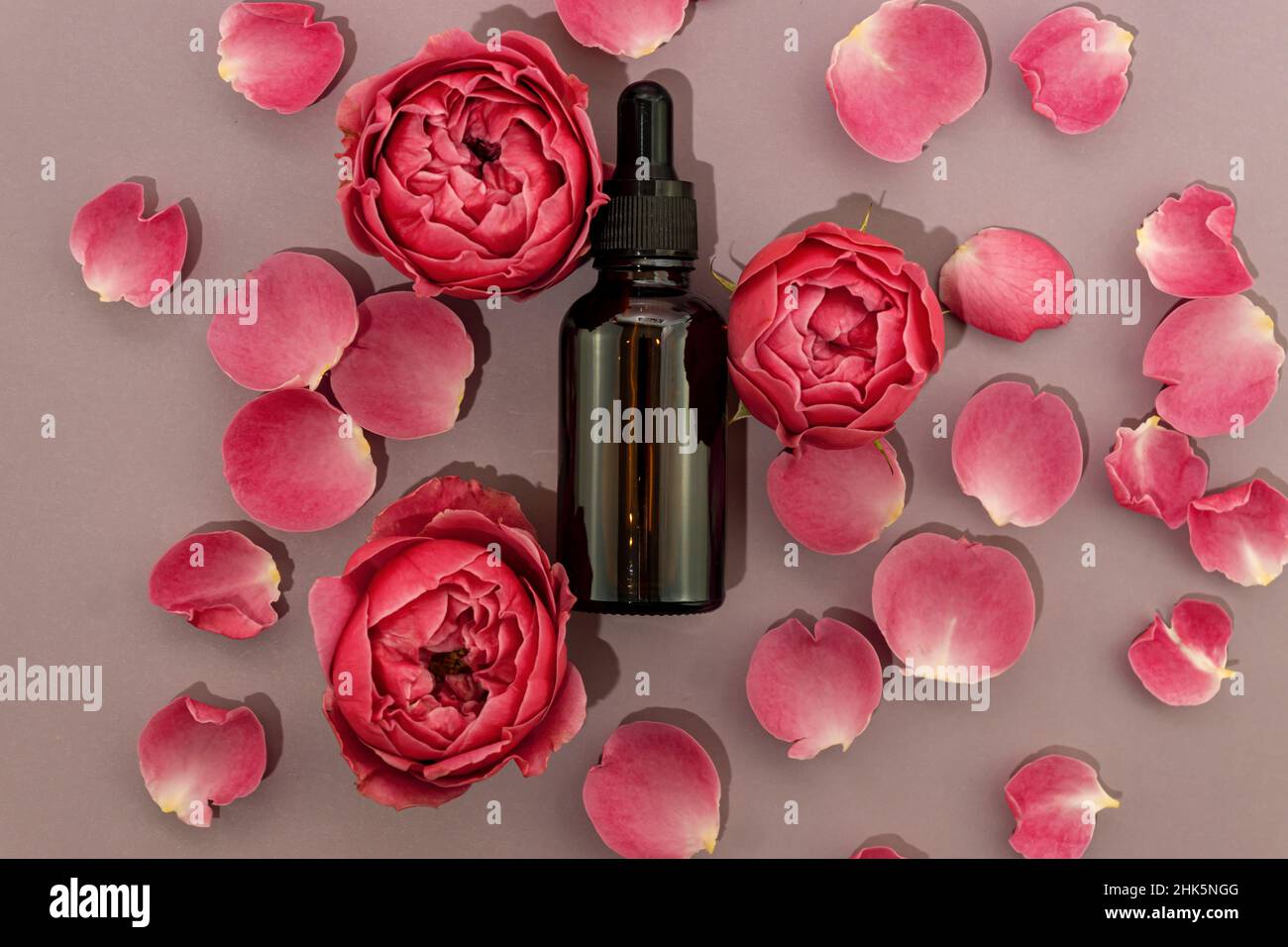 Homemade skincare natural rose essential oil product on Pink rose ...