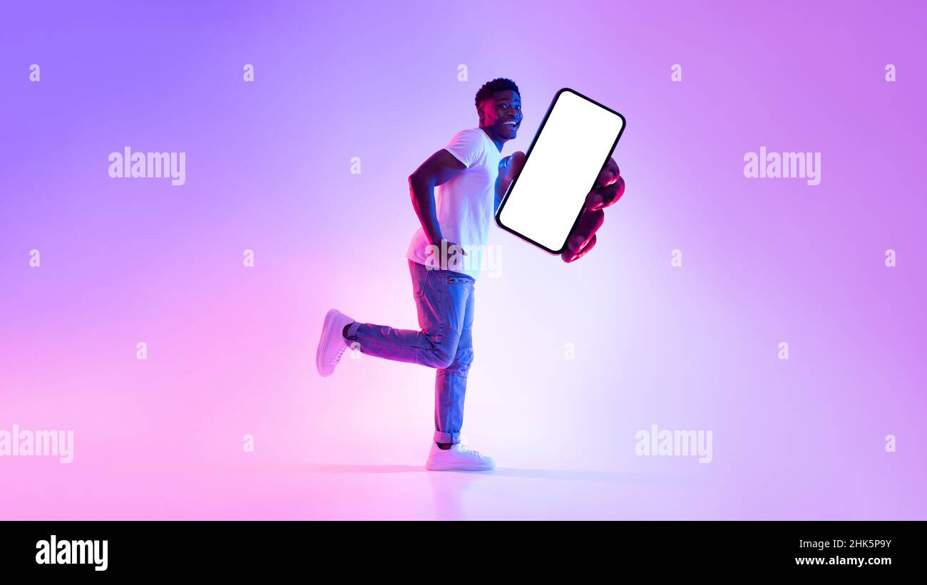 Smartphone screen mockup. Positive young black man running with blank ...