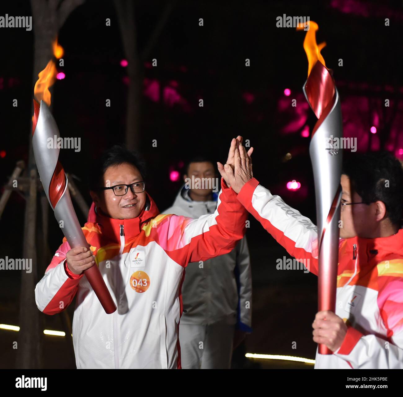 Beijing, China. 2nd Feb, 2022. Torch bearer Zhang Yue (L) attends the Beijing 2022 Olympic Torch ...