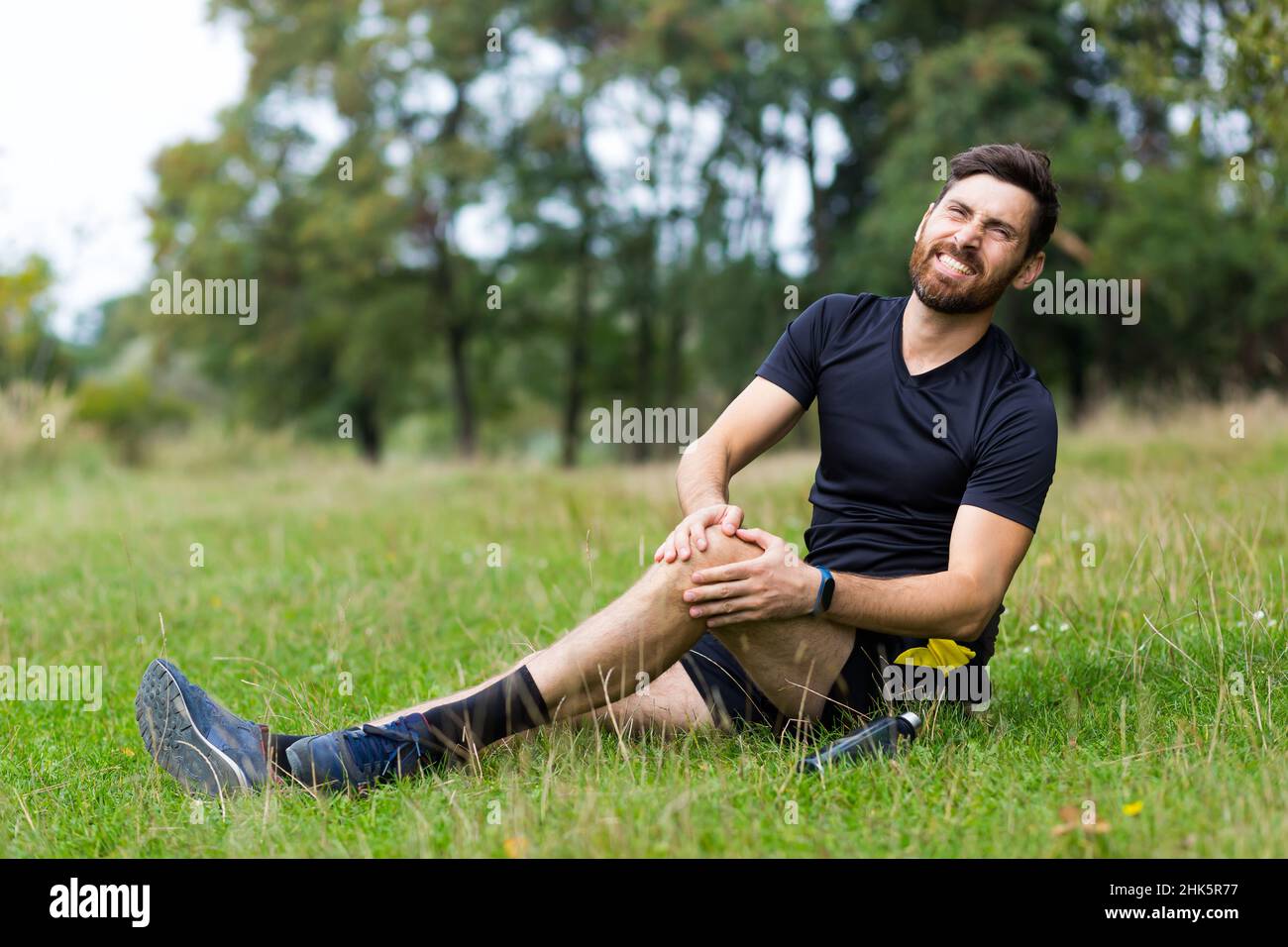 Athlete male injured during training, has severe leg pain, muscle aches ...