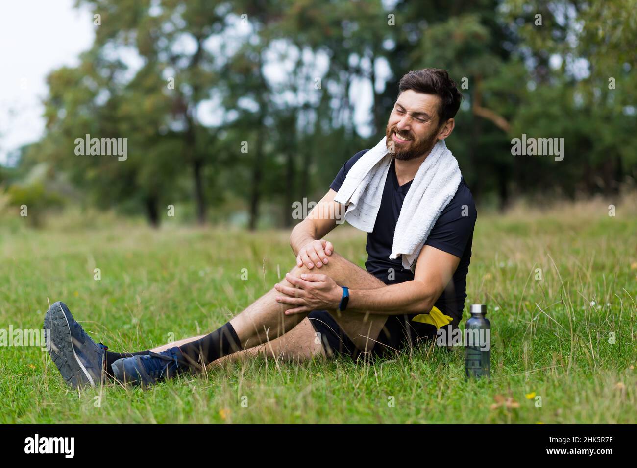 Athlete male injured during training, has severe leg pain, muscle aches ...