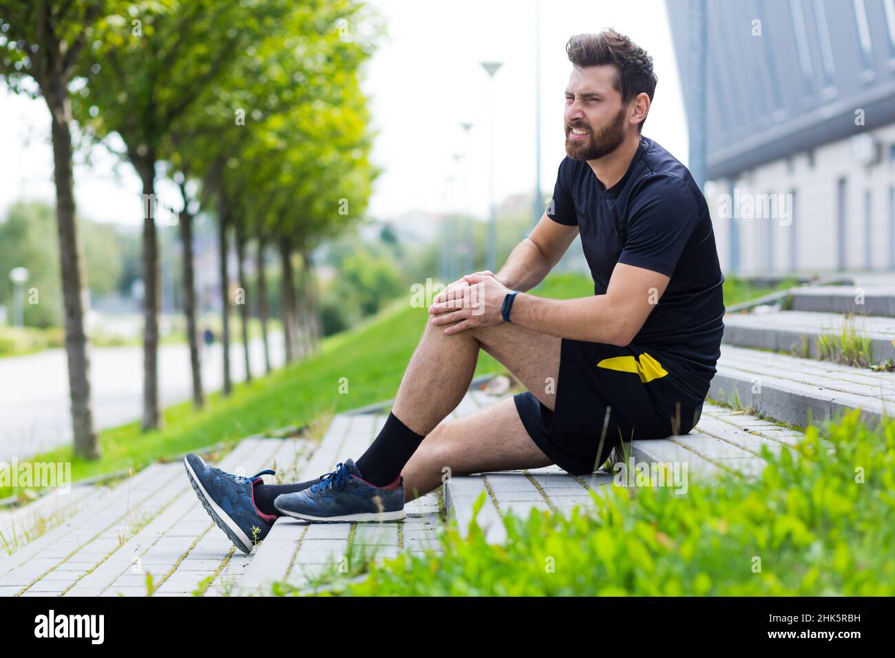 Athlete male injured during training, has severe leg pain, muscle aches ...