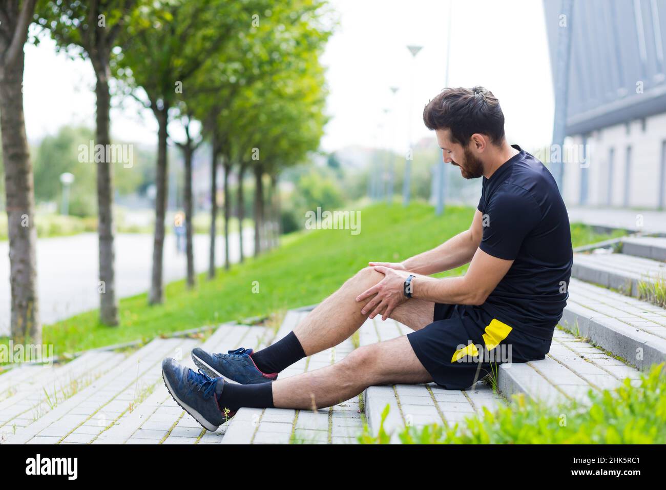 Athlete male injured during training, has severe leg pain, muscle aches ...