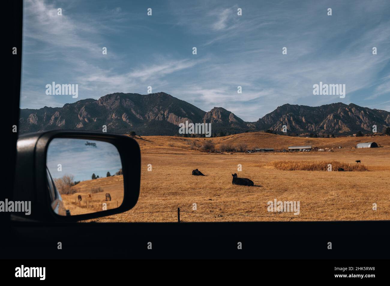 Colorado field view with rocky mountains in the background from a car ...