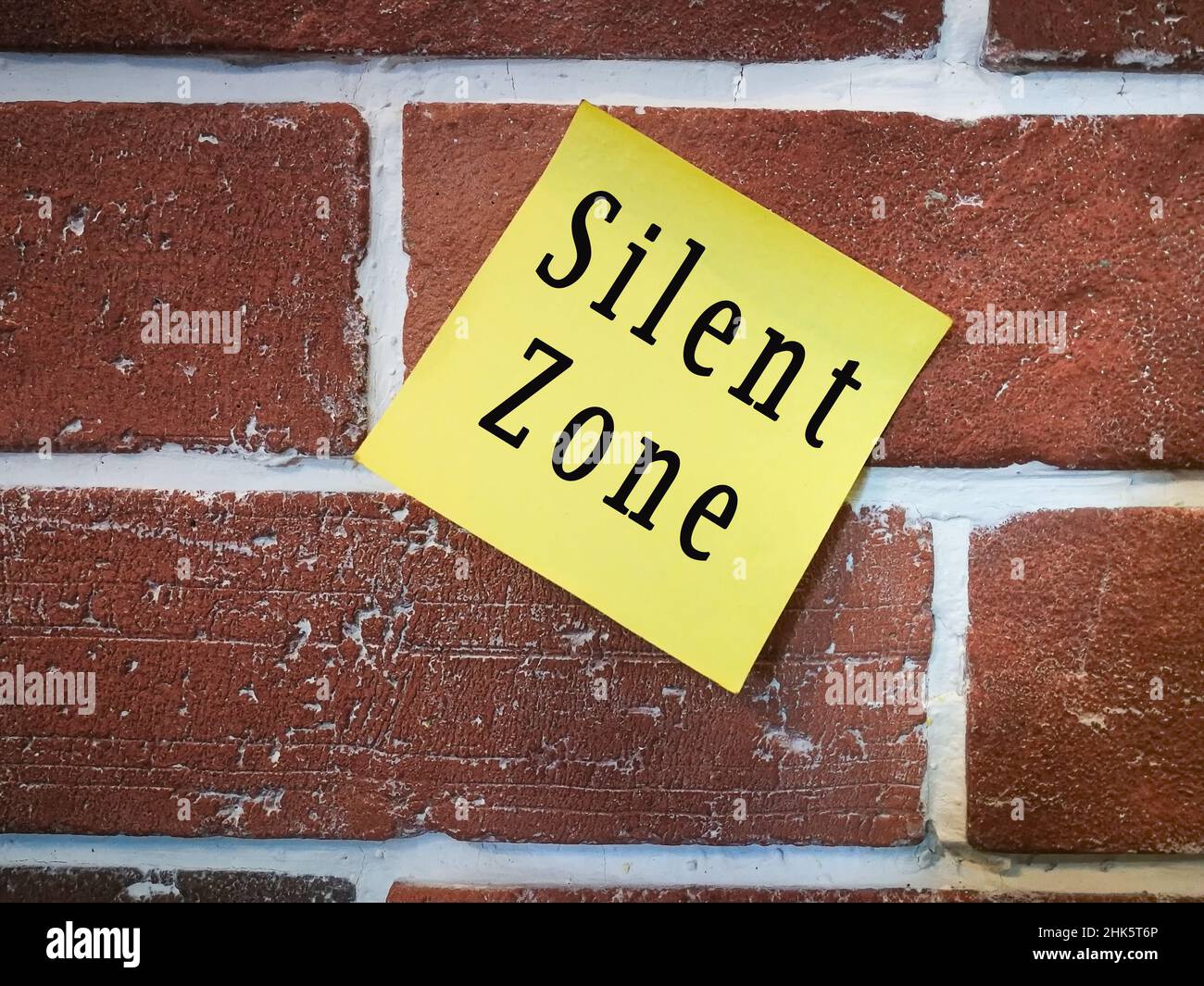 Silent zone text on sticky yellow note on brick wall Stock Photo - Alamy