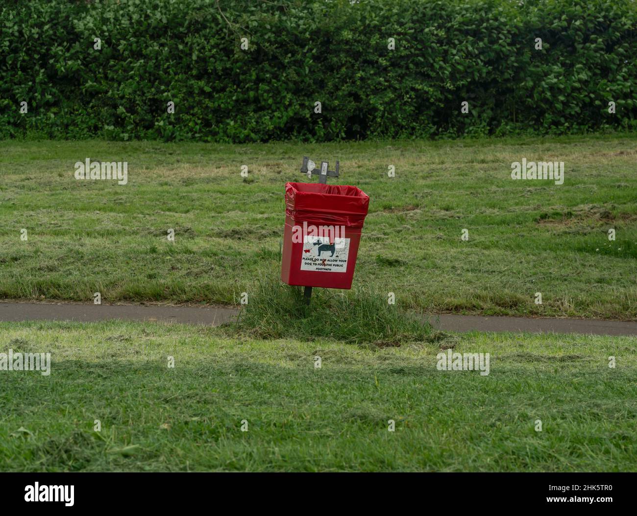 Dog Poo Bin on joined Footpath and Cycle Path Stock Photo - Alamy