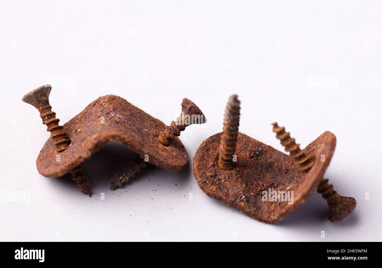 metal angle brackets with corrosive rust and damaged screws, white ...
