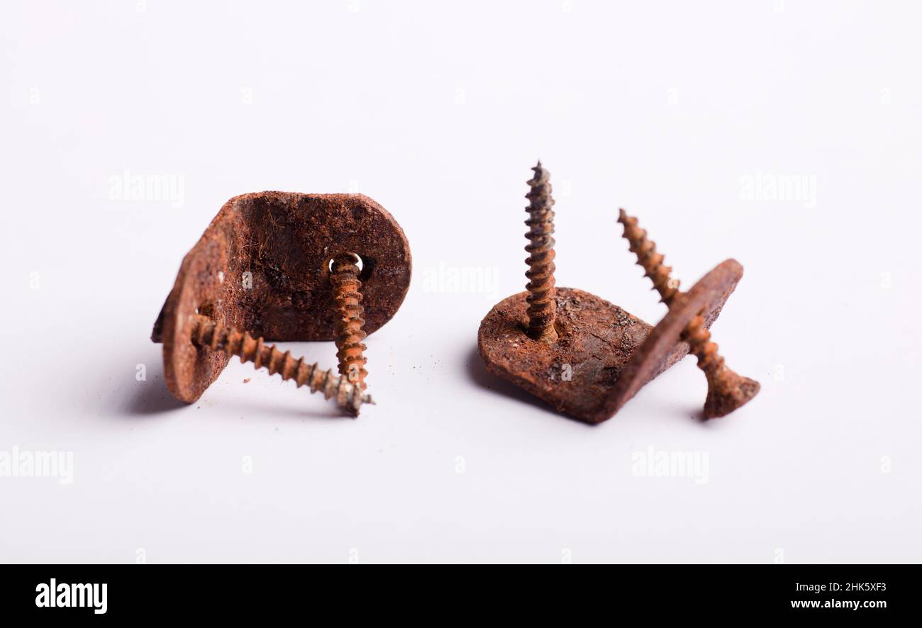metal angle brackets with corrosive rust and damaged screws, white ...