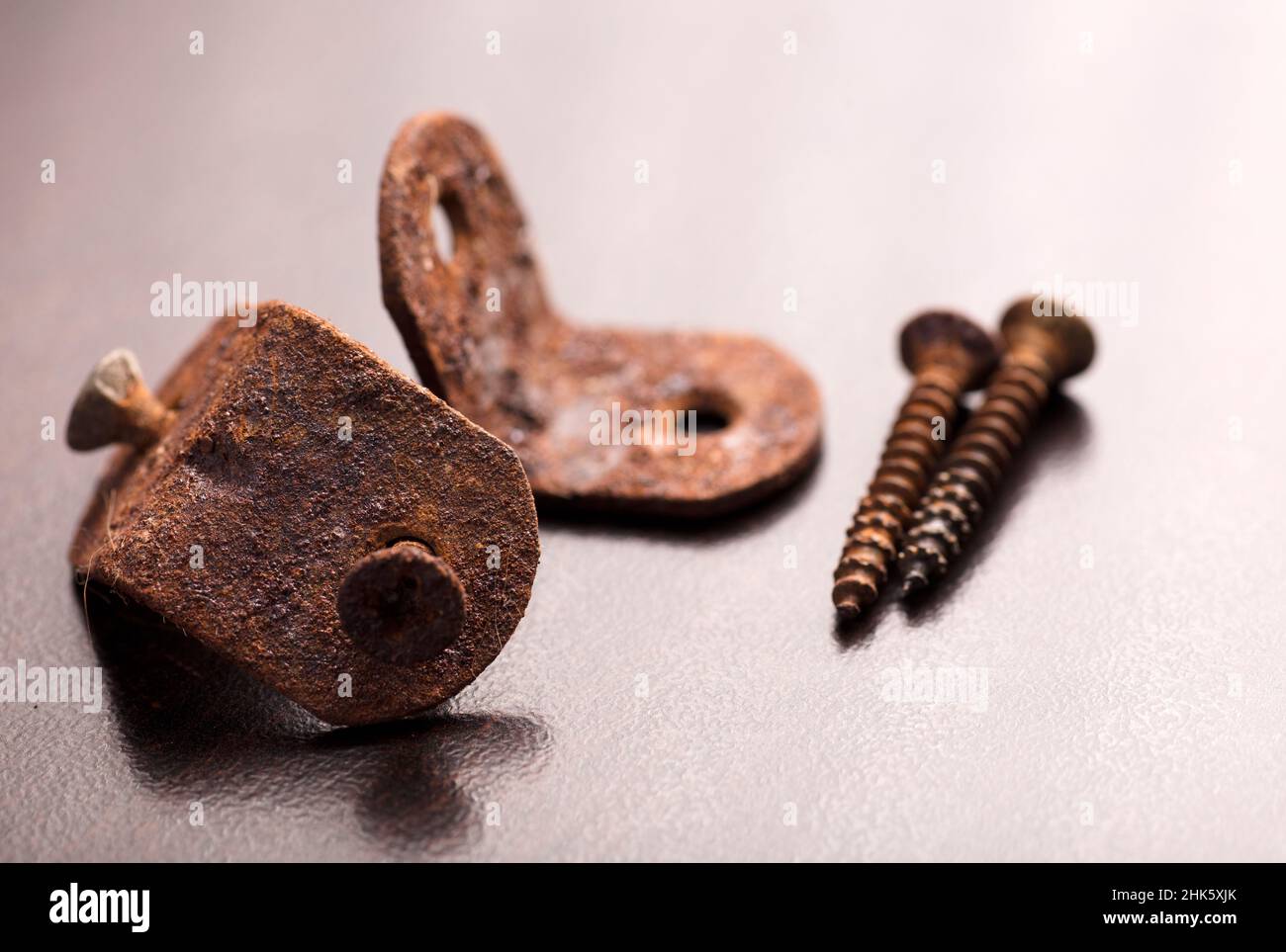 metal angle bracket with corrosive rust and deteriorated screws ...