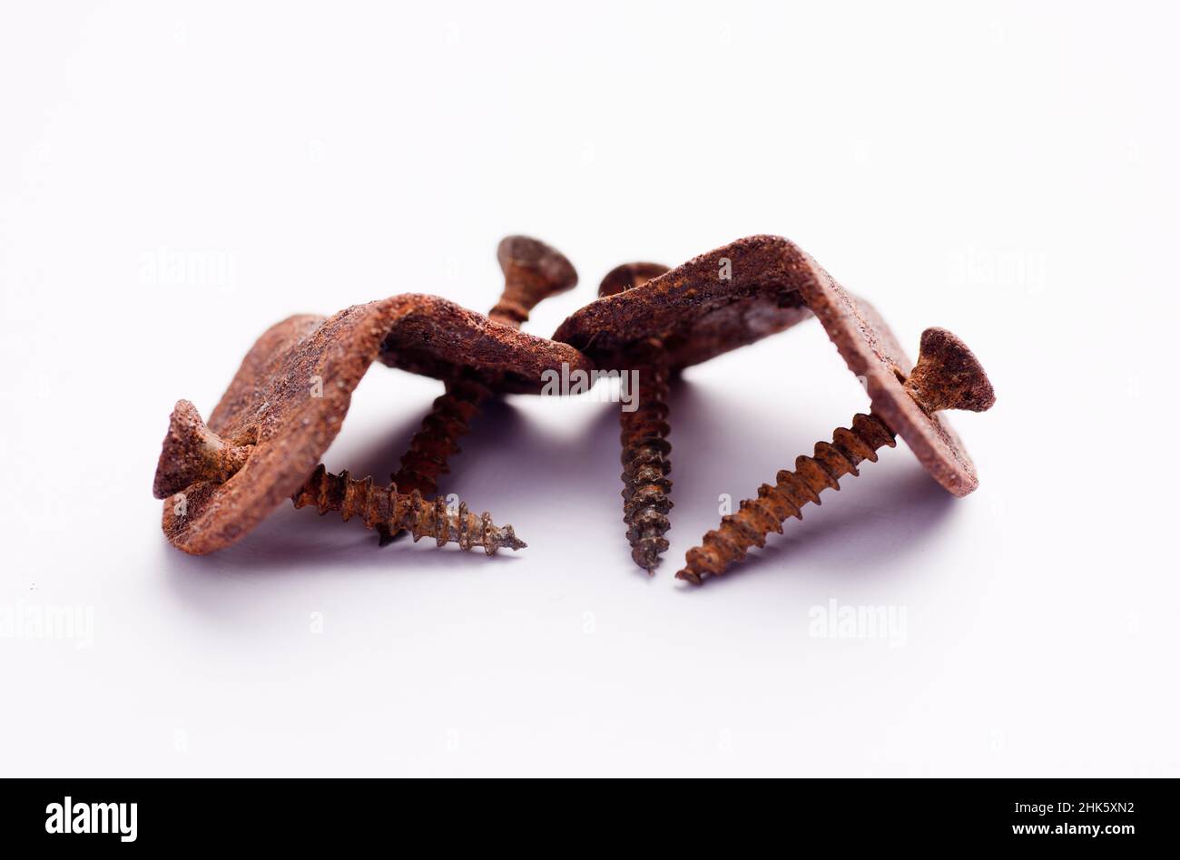 metal angle brackets with corrosive rust and damaged screws, white ...