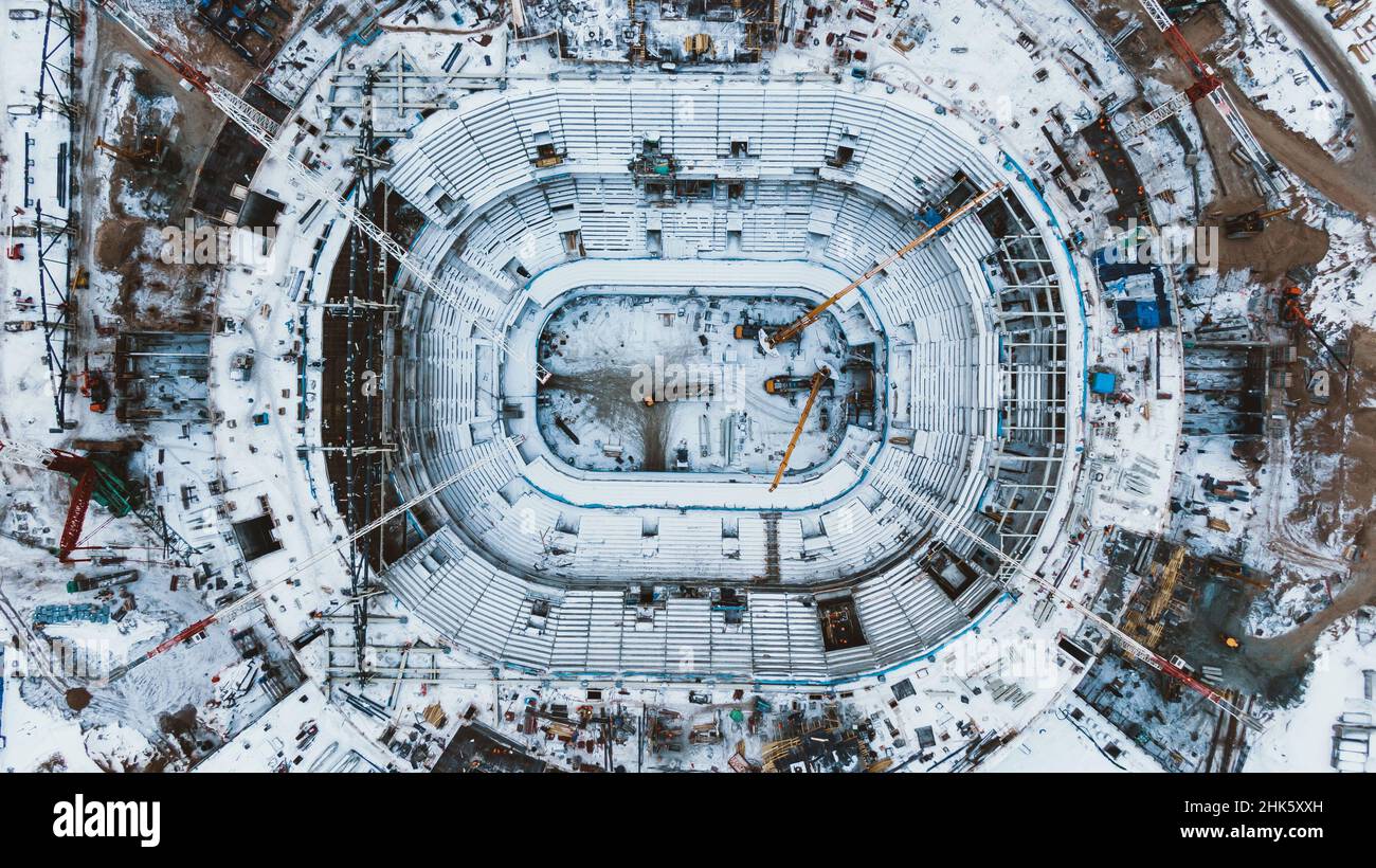 Snowy football field inside stadium with seats for spectators covered ...