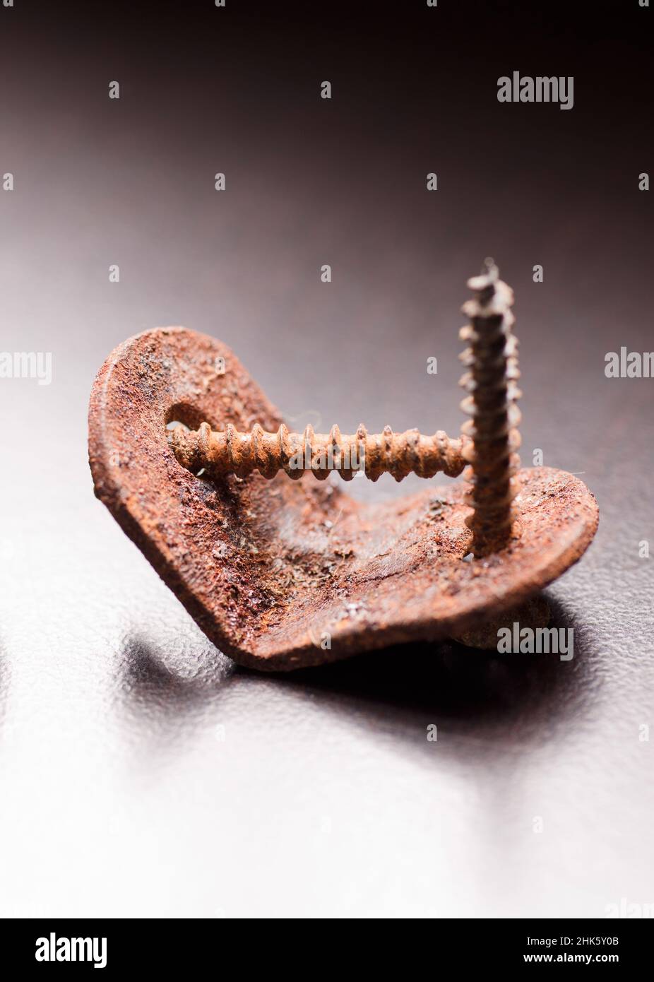 metal angle bracket with corrosive rust and deteriorated screws, oxide ...