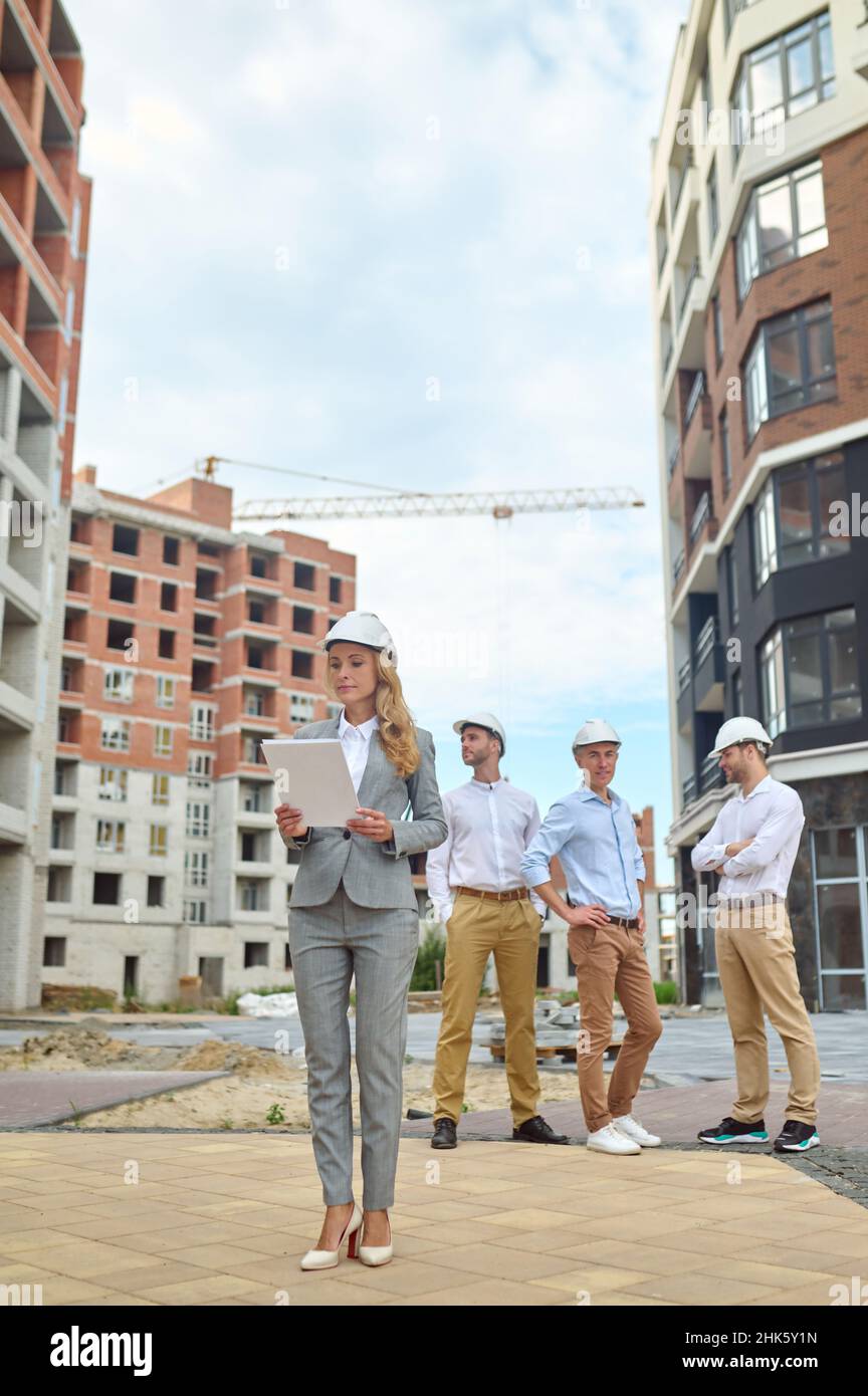 Focused construction inspector scrutinizing project documentation ...